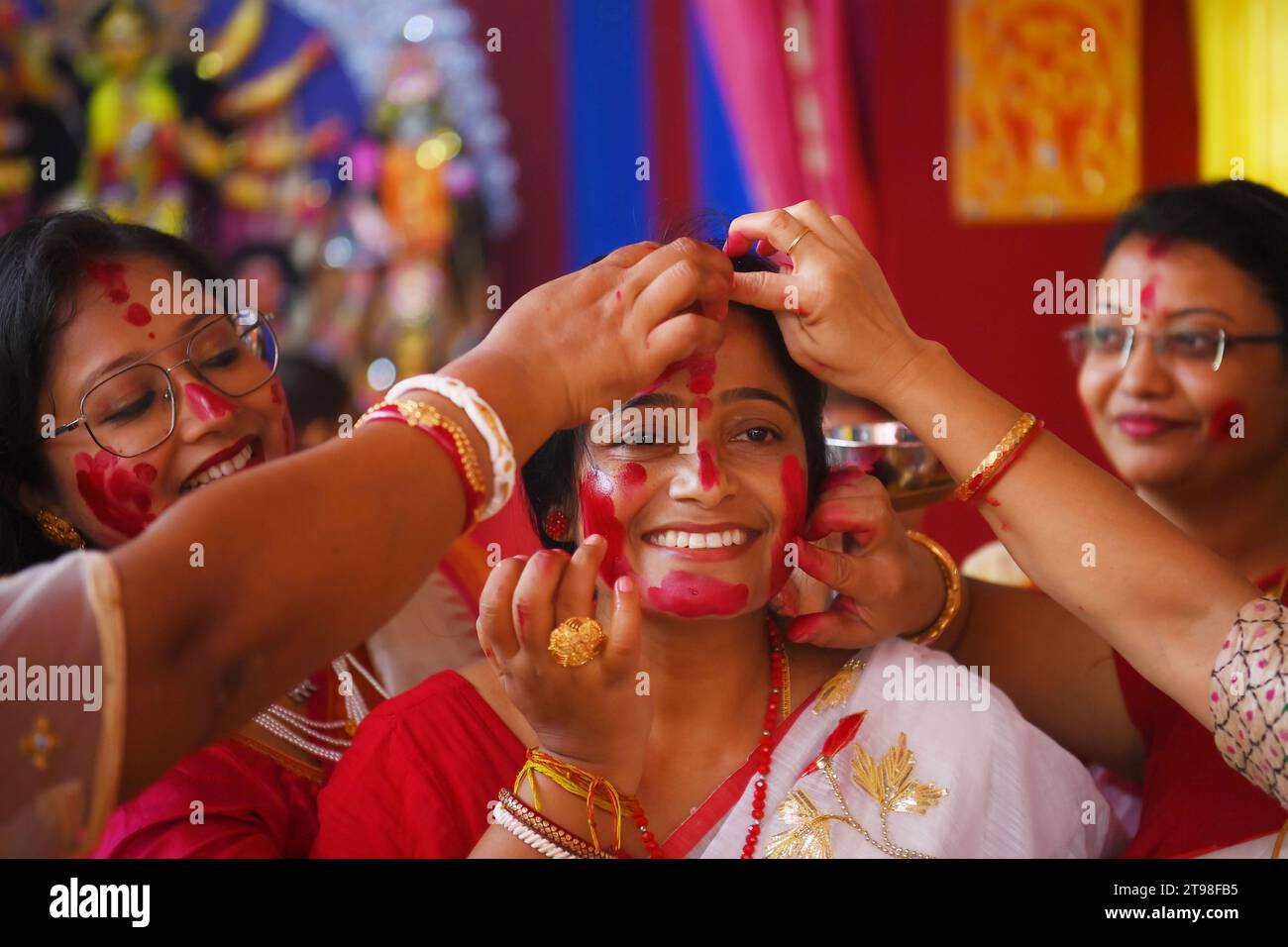 Married ladies smear red Sindoor or Vermillion, a ritual known as ...