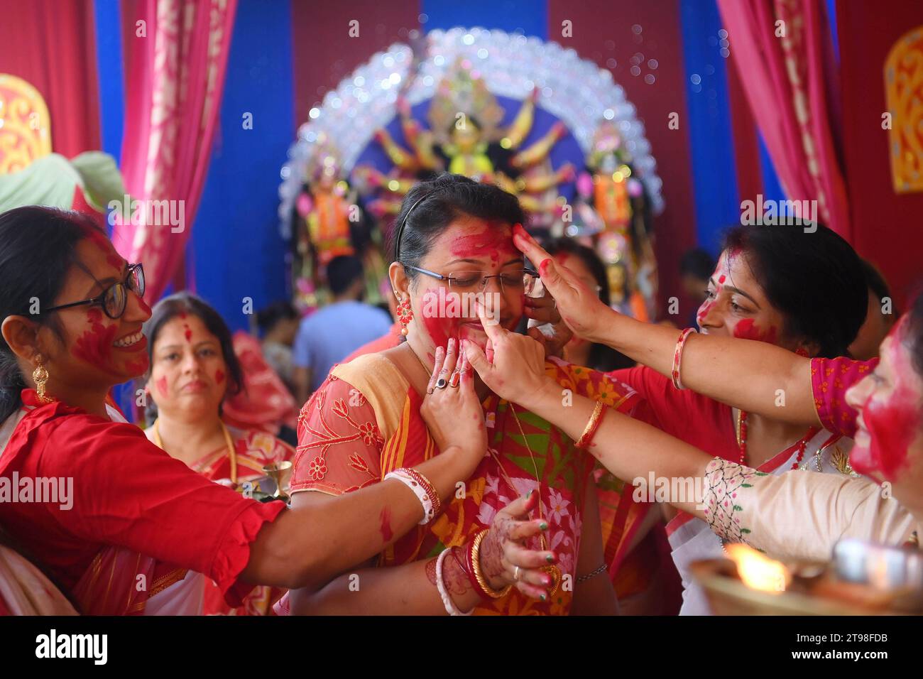 Married ladies smear red Sindoor or Vermillion, a ritual known as ...