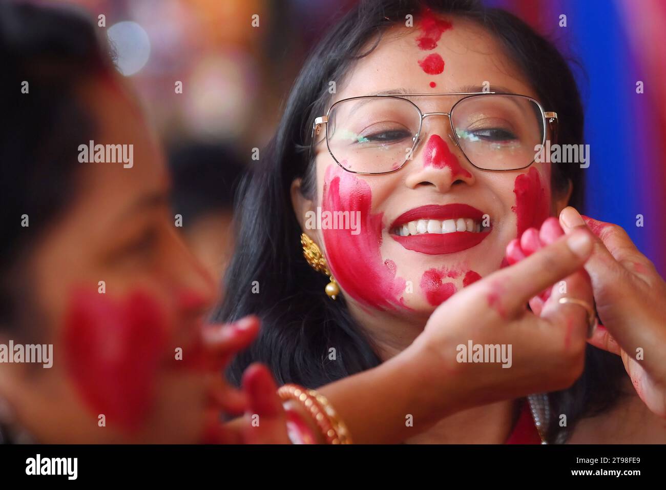 Married ladies smear red Sindoor or Vermillion, a ritual known as ...