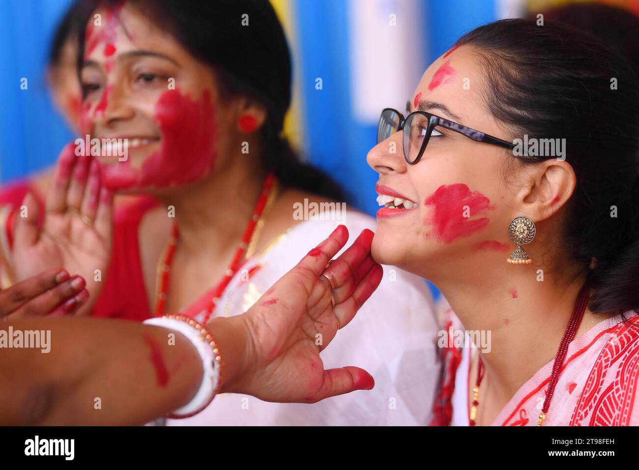 Married ladies smear red Sindoor or Vermillion, a ritual known as ...