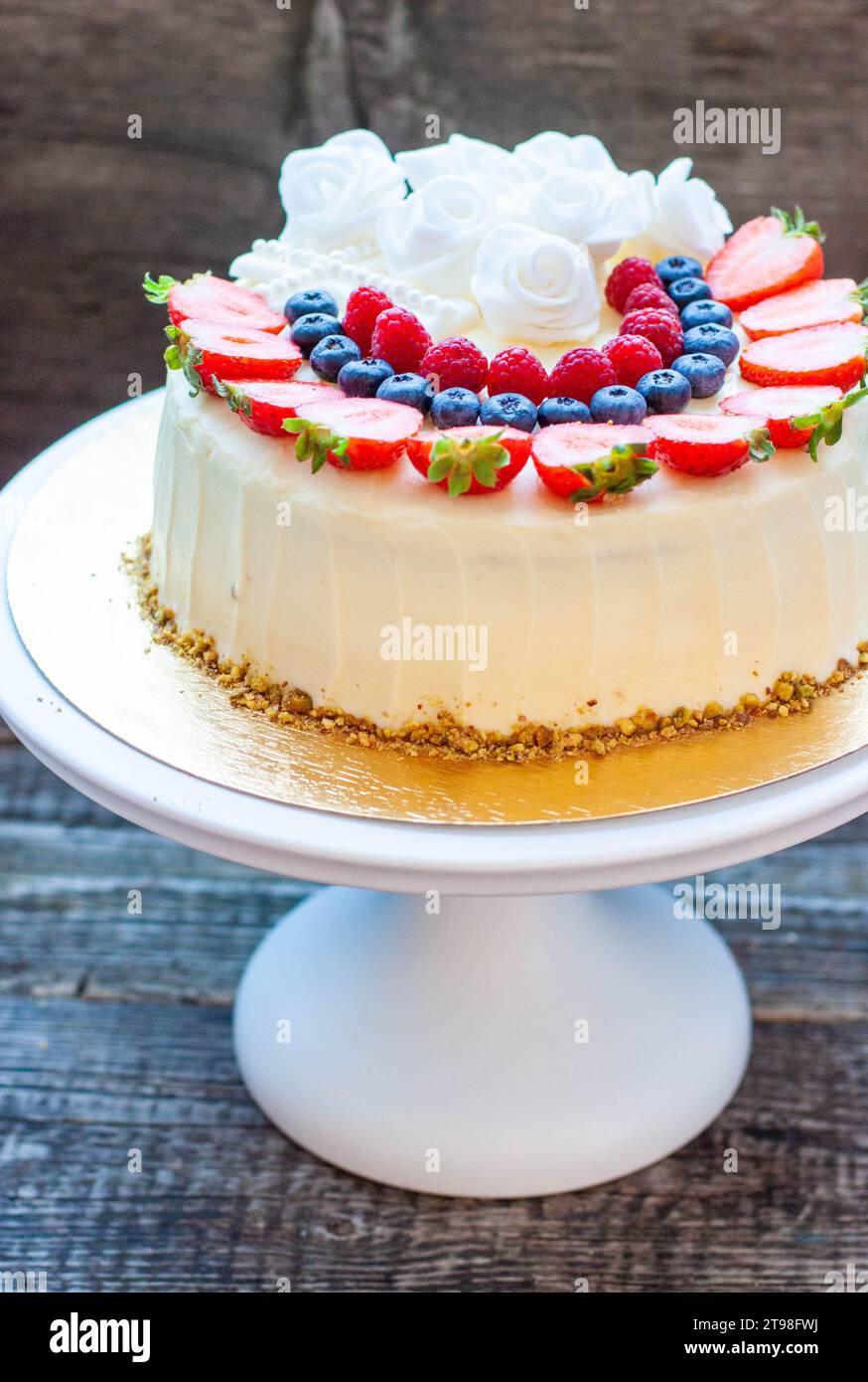 Christening cake for baby. Decoration with fresh berries and fondant flowers. Christening party ...