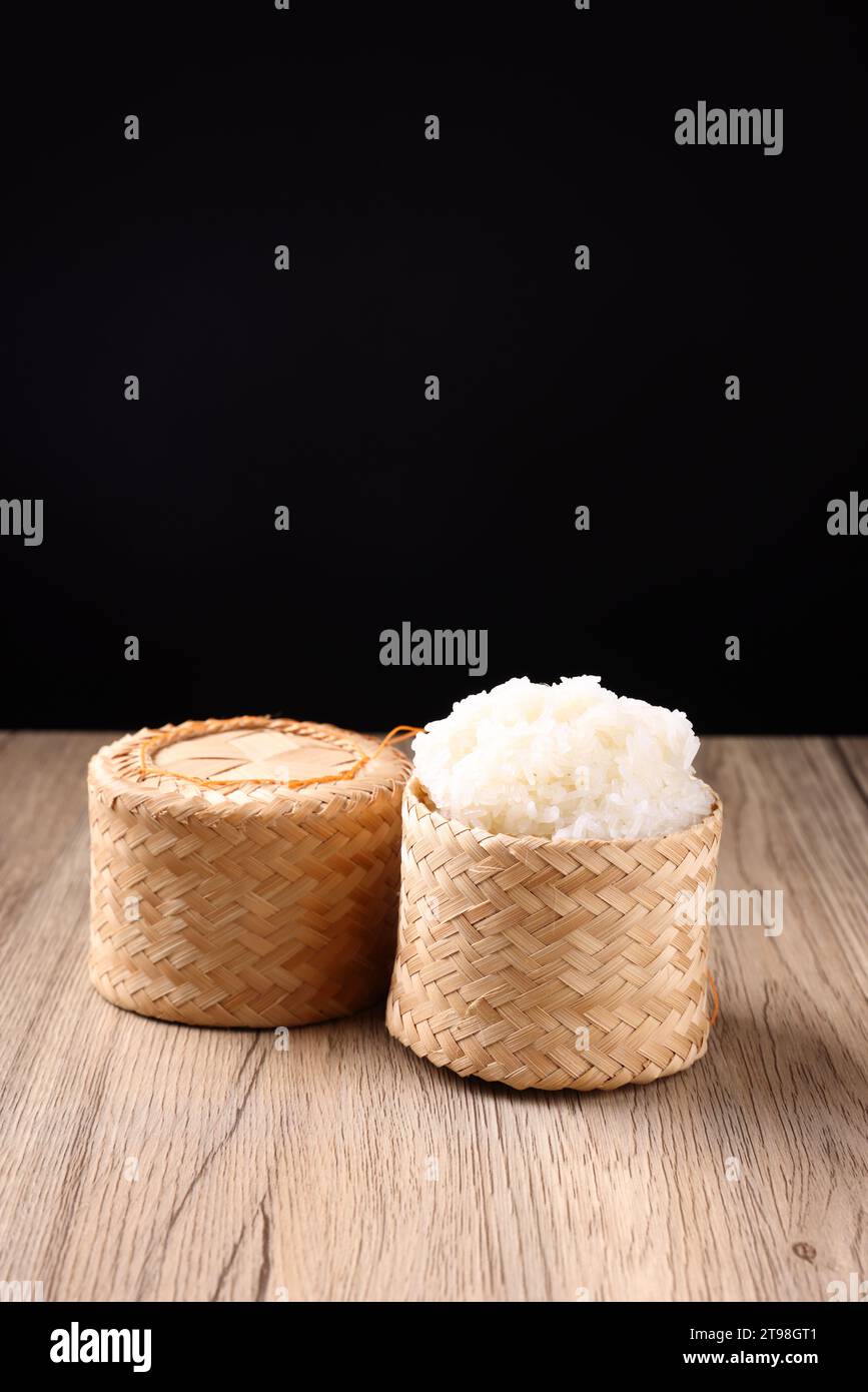 Sticky rice in the small basket with wooden backgrounders isolated in ...