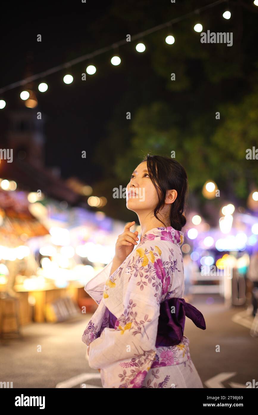 Japanese woman in yukata in night city Stock Photo - Alamy