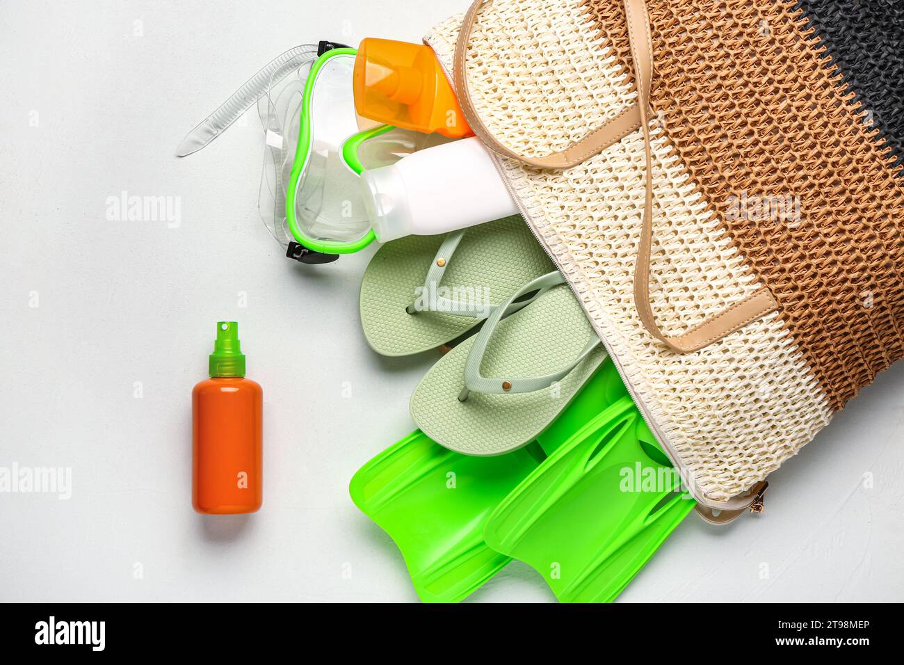 Bottles of sunscreen cream with beach accessories on white background ...