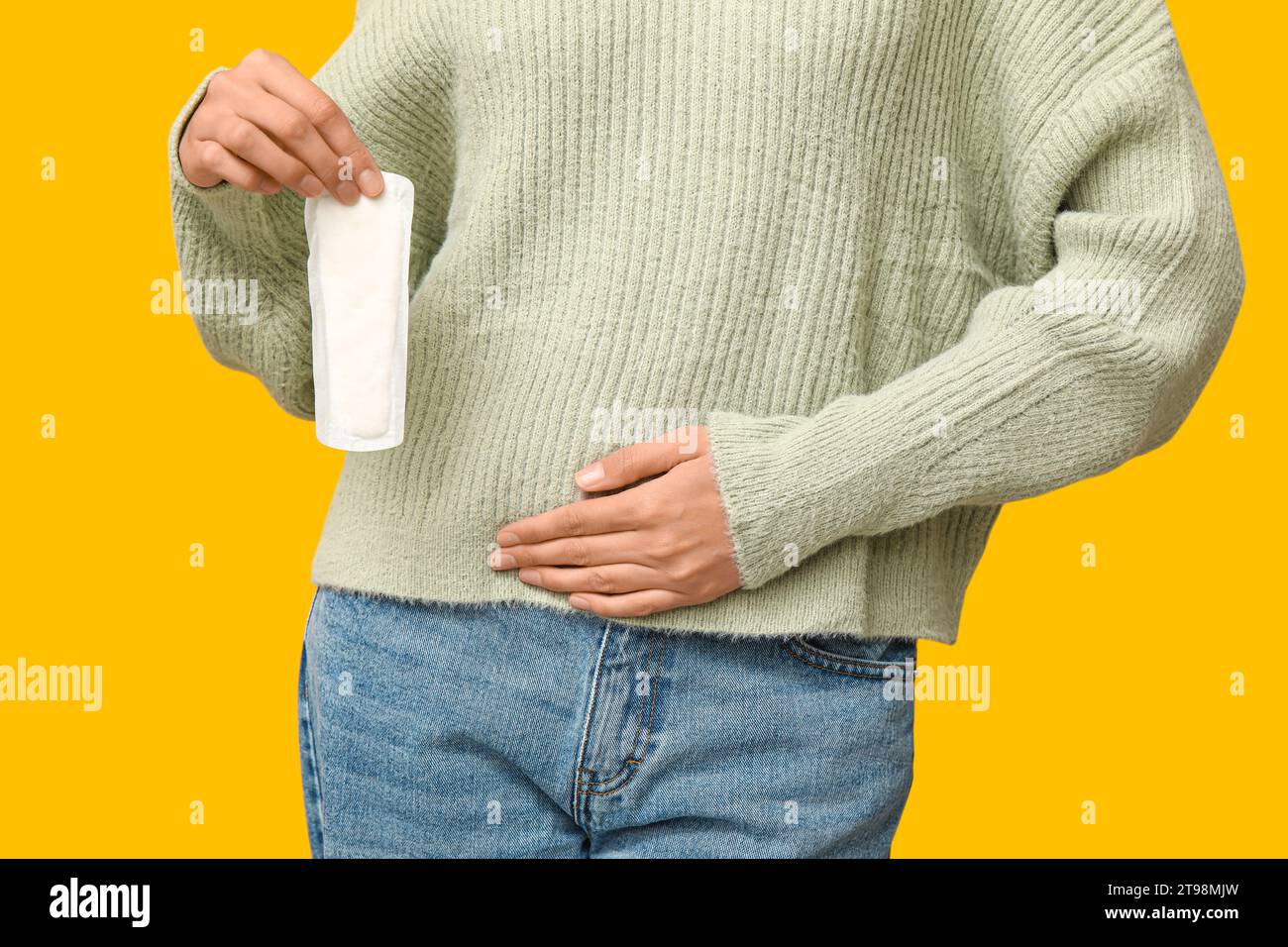 Beautiful young woman with menstrual pad on yellow background Stock ...