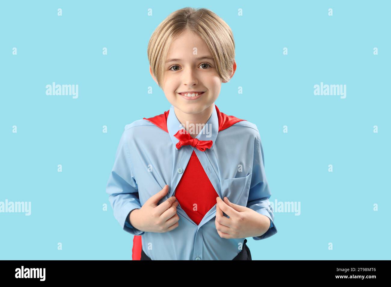 Little actor dressed as superhero on blue background Stock Photo - Alamy