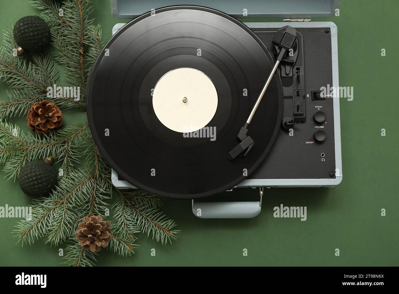 Vintage record player with vinyl disc and Christmas decorations on ...