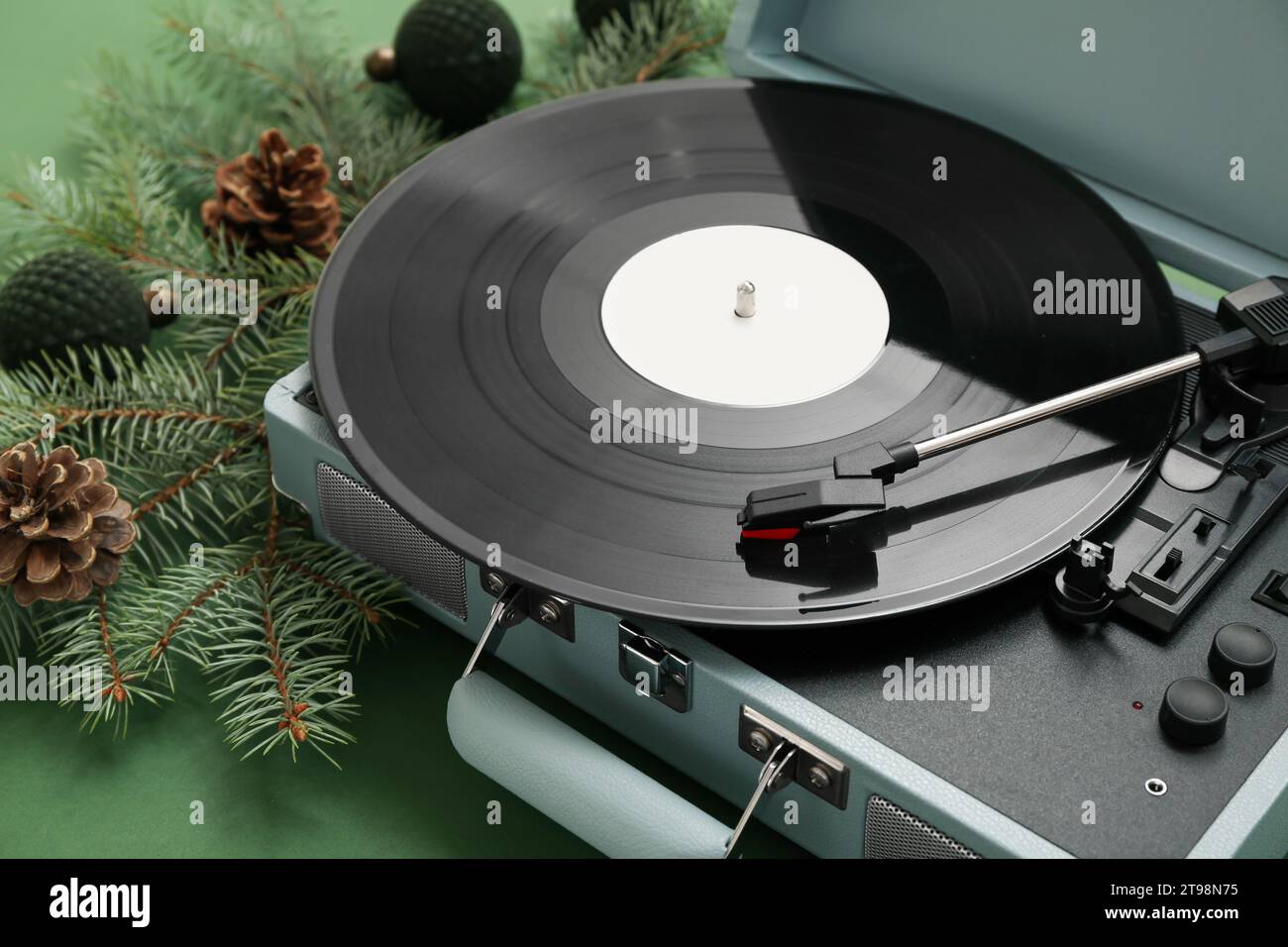 Vintage record player with vinyl disc and Christmas decorations on ...