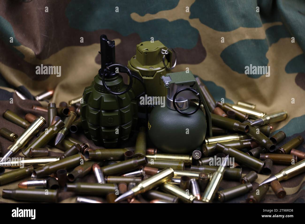 Different types of ammunition and grenades on a camouflage background ...