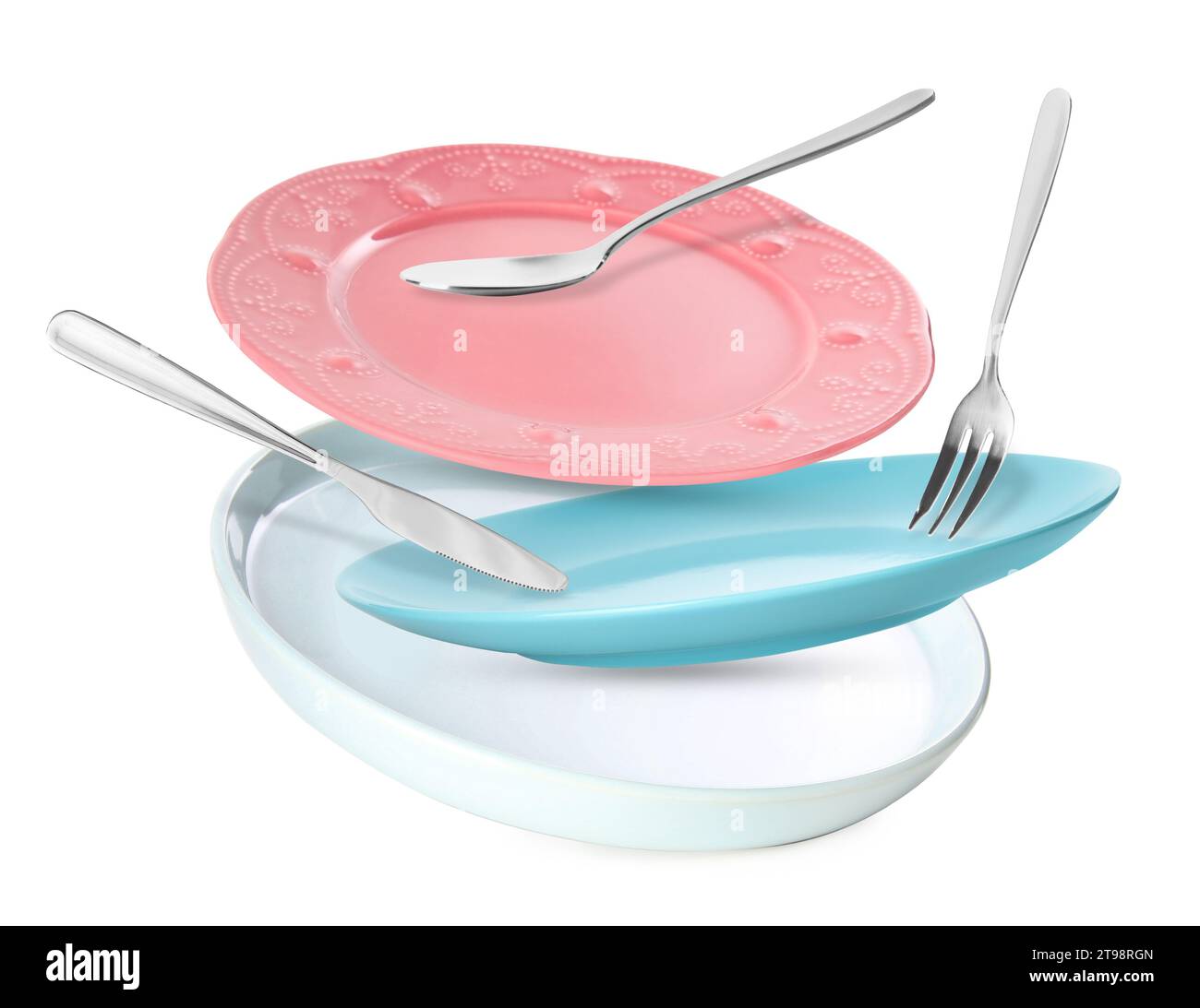 Clean plates, spoon, knife and fork falling on white background Stock ...