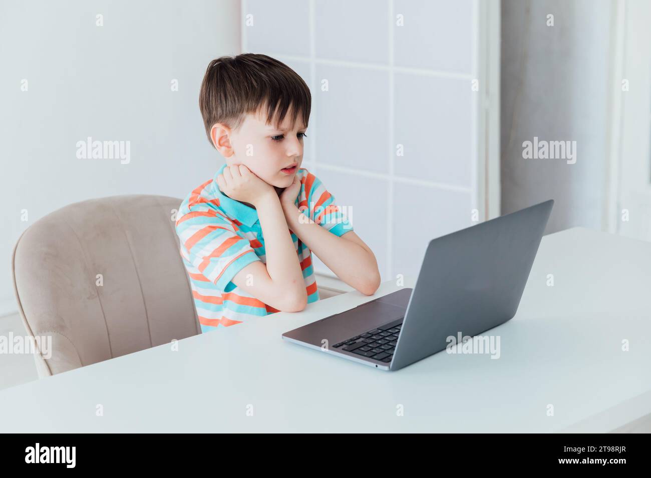 Boy doing online learning with laptop Stock Photo - Alamy