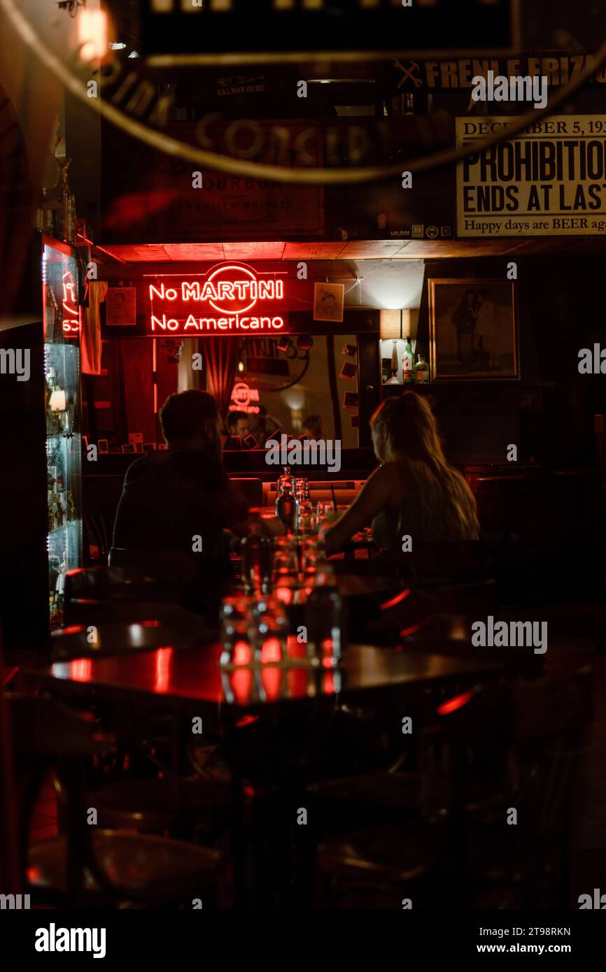 Two people in a cozy atmosphere illuminated by red lighting from the ...