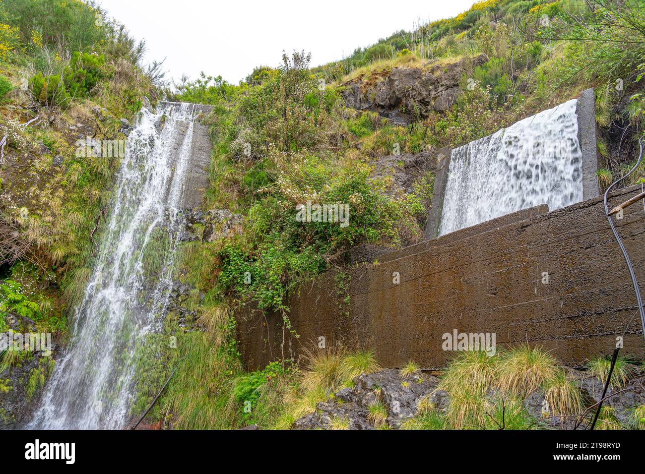 Waterfalls in the form of a cascade in a levada channel to transport ...