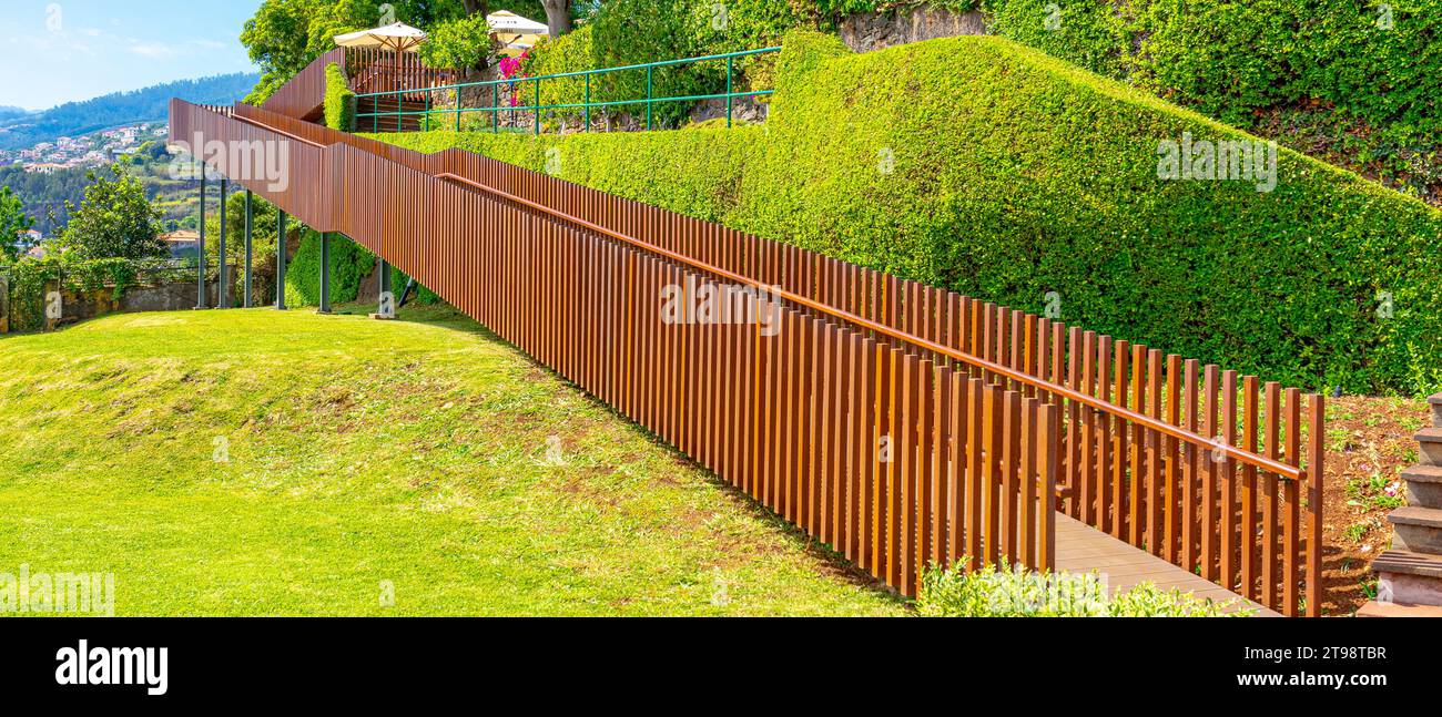 ramp with a wooden fence for people in wheelchairs to move inside the ...