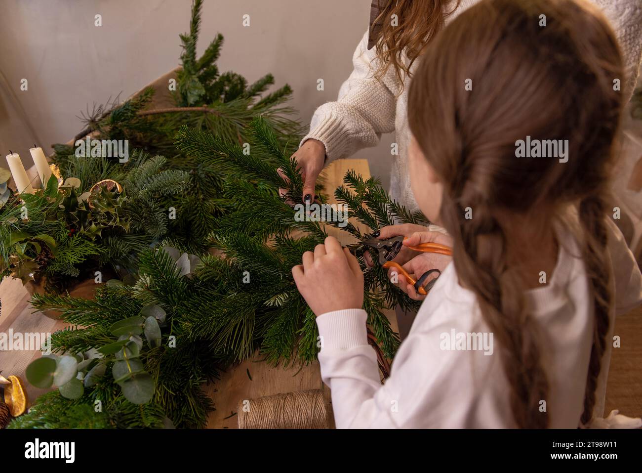 Close-up of faceless young mother with little daughter together making ...