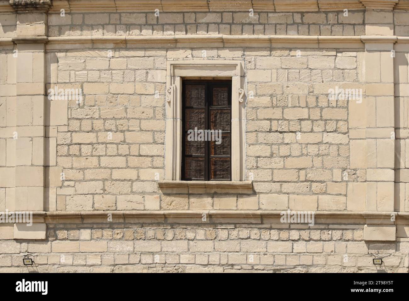 Very old window in brick stone wall of castle or fortress of 18th ...