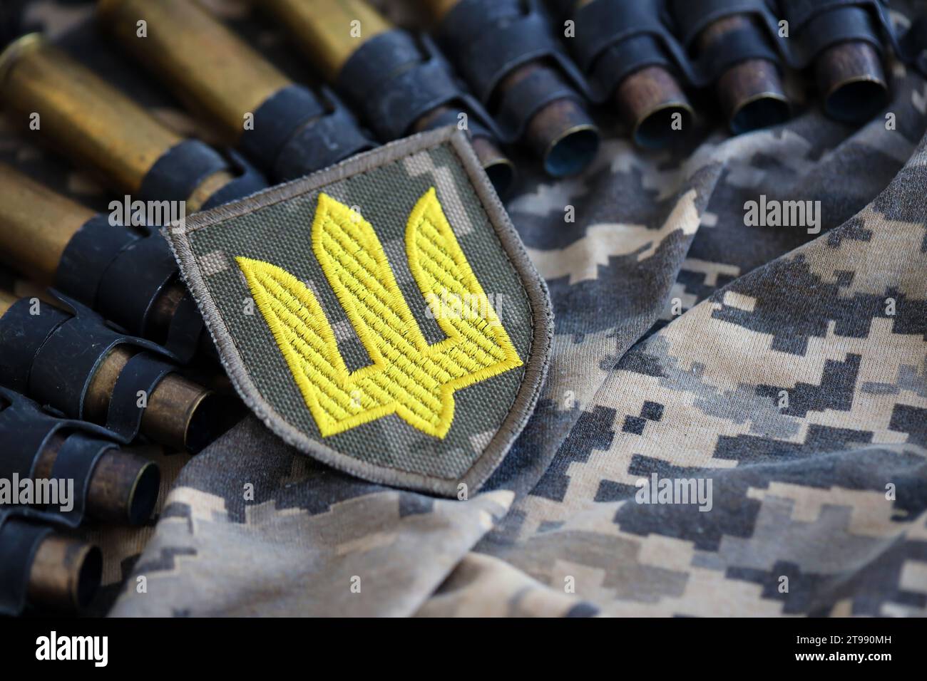 Ukrainian army symbol on machine gun belt lies on ukrainian pixeled ...