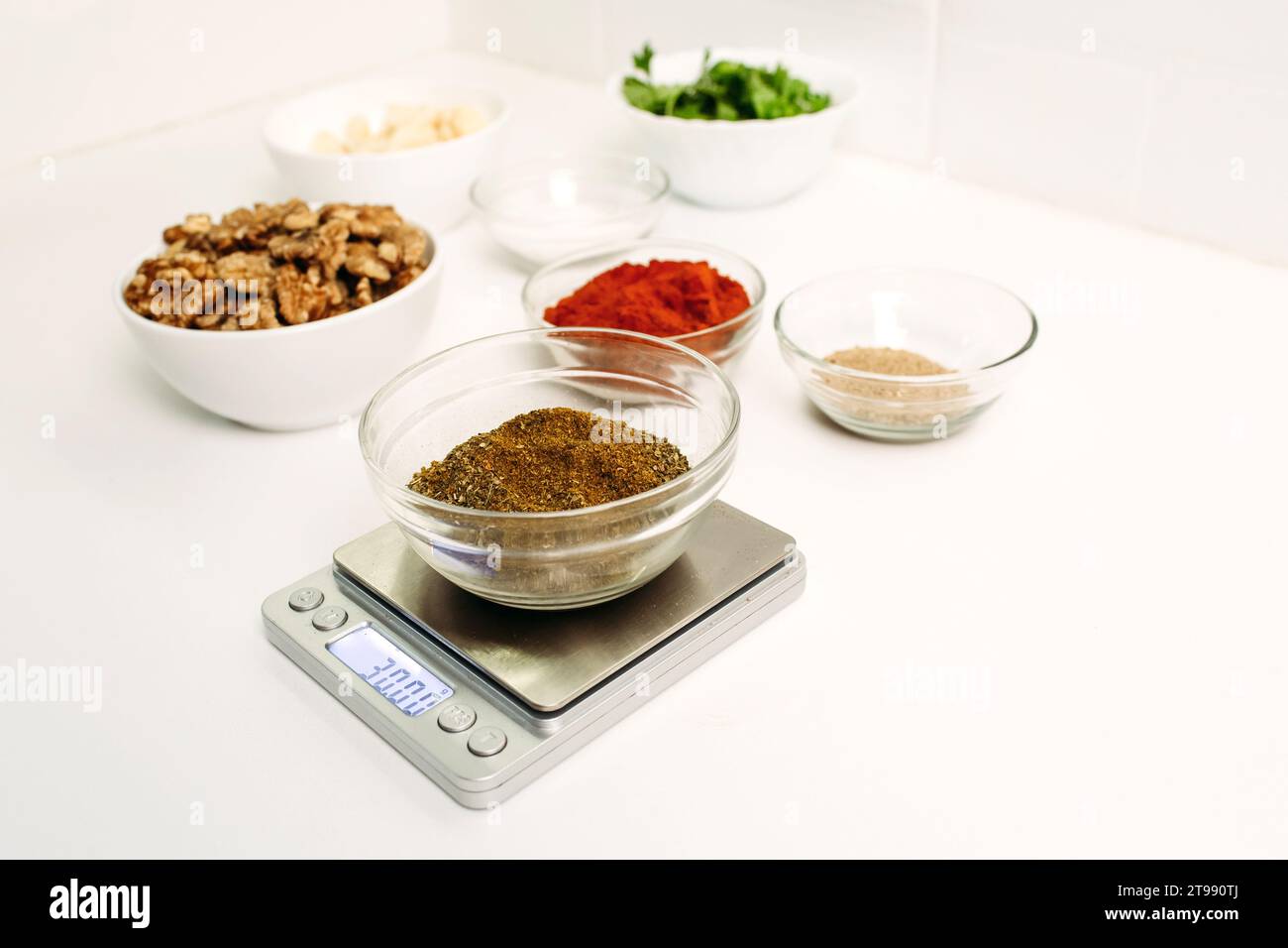 Weighing portions of ingredients to prepare a dish. There is a mixture of seasonings on the ...