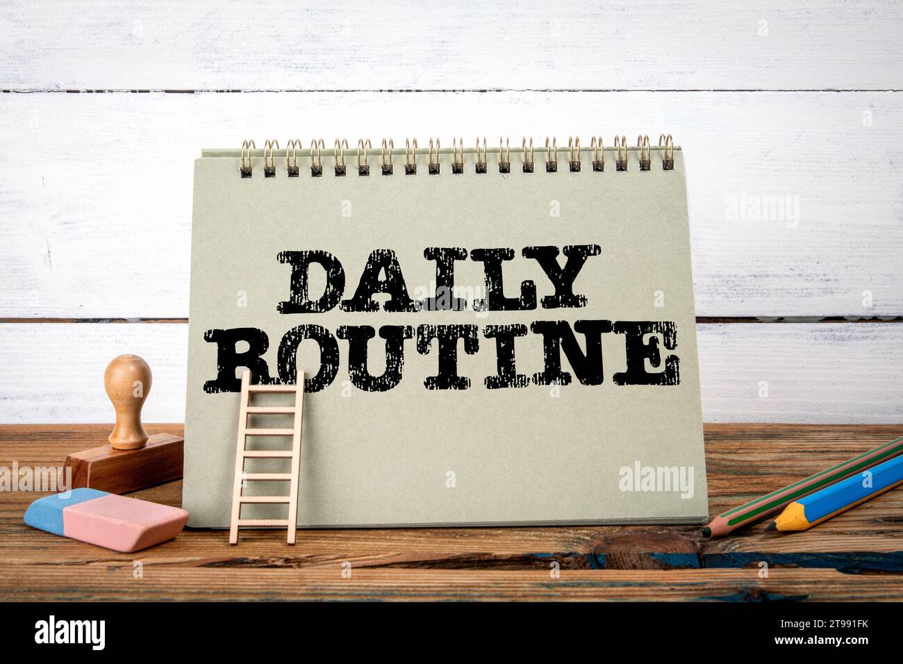 Daily Routine. Green notepad on wooden texture table and white ...