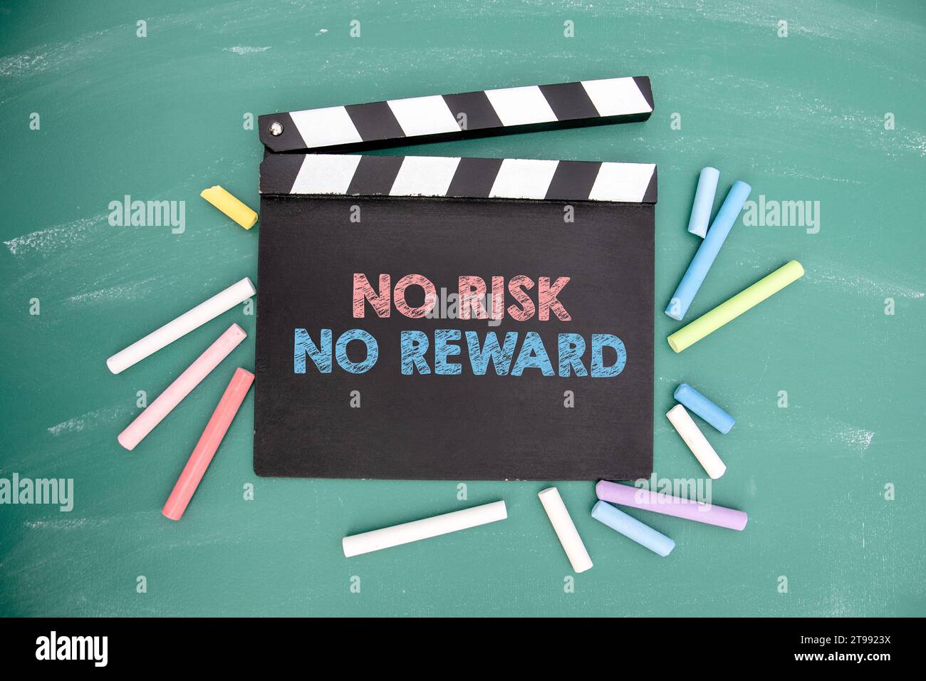 No Risk No Reward. Movie clapper and colored pieces of chalk Stock ...