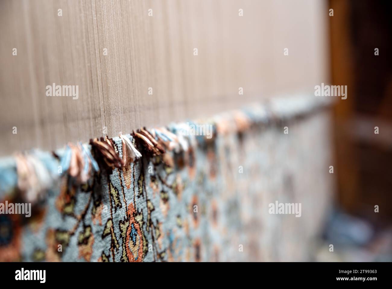 weaving carpet ,a diligent woman makes a traditional carpet by hand ...