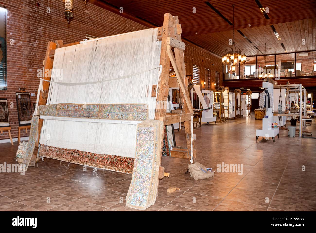 weaving carpet ,a diligent woman makes a traditional carpet by hand ...
