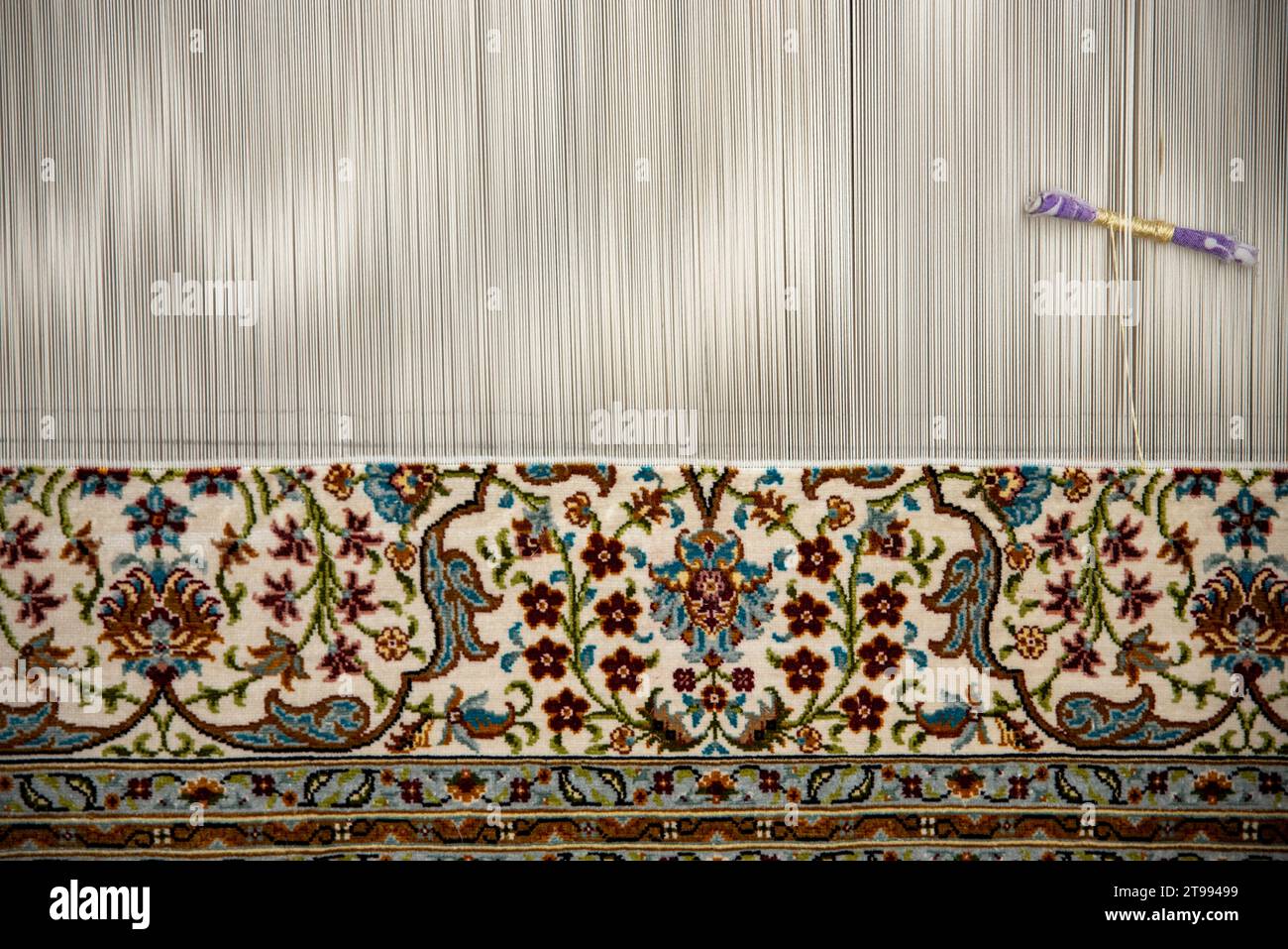 weaving carpet ,a diligent woman makes a traditional carpet by hand ...