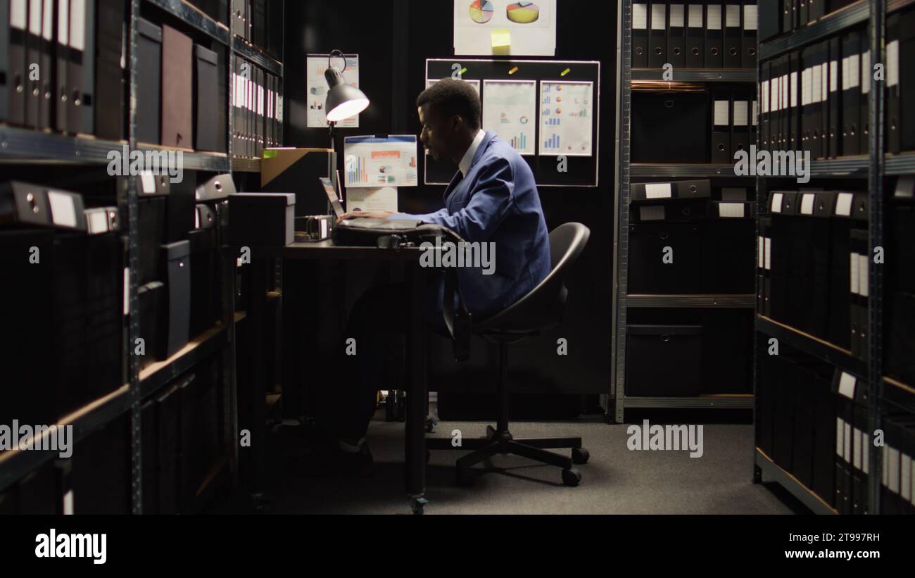 African american private detective walks into archive room with a ...