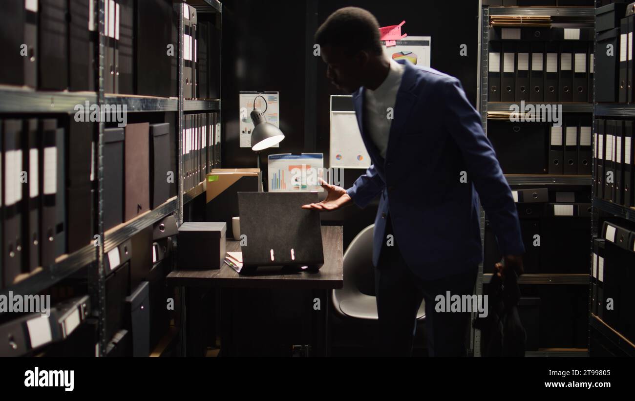 Male private investigator exits office room after packing his personal ...