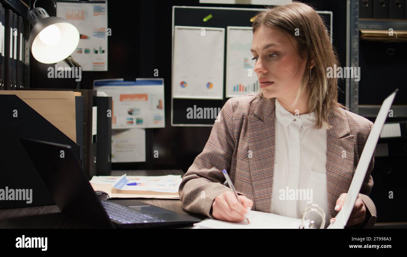 Detective walks inside office with case folder, scrutinising evidence ...