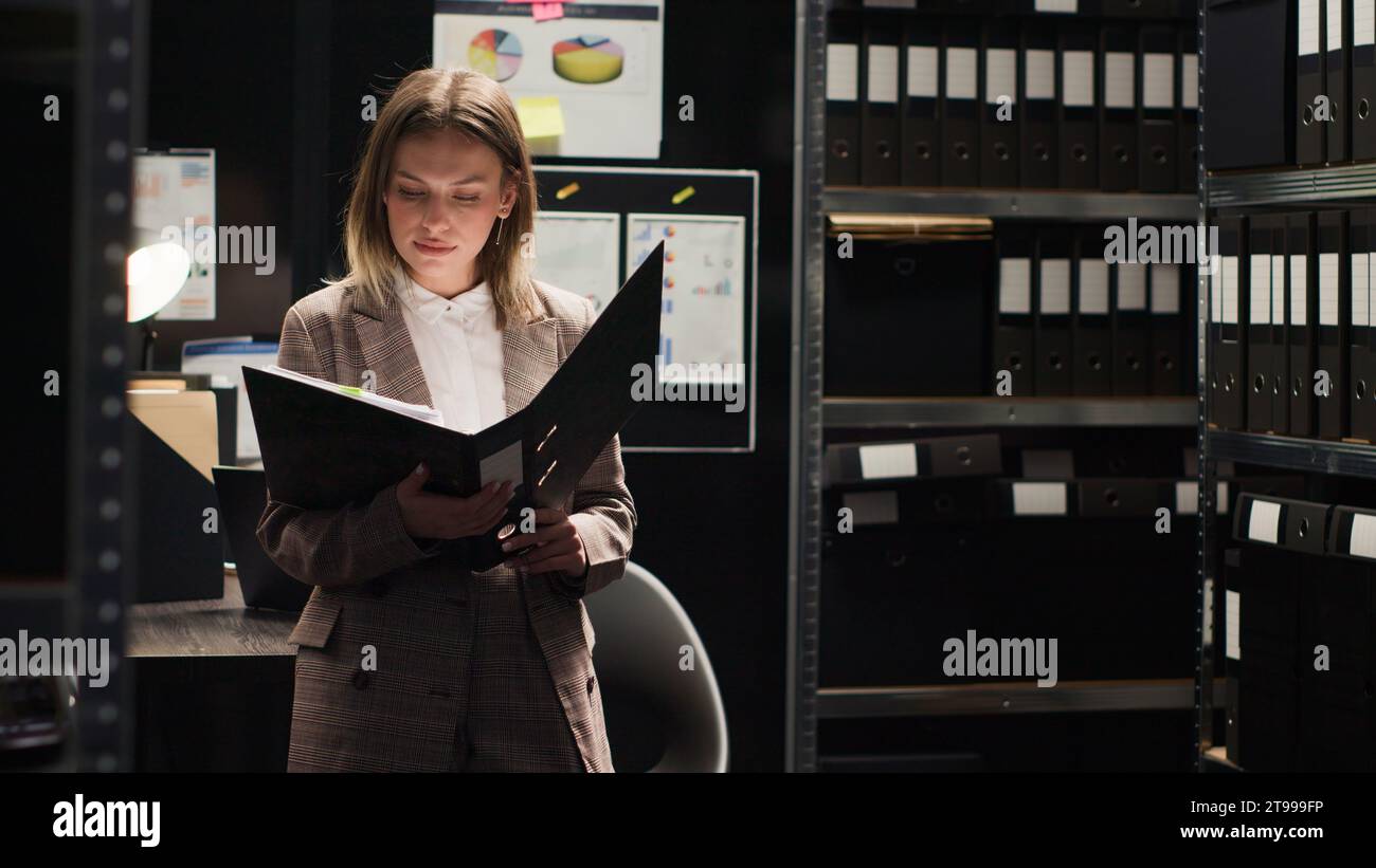 Female private detective conducting investigation in office, focused on ...