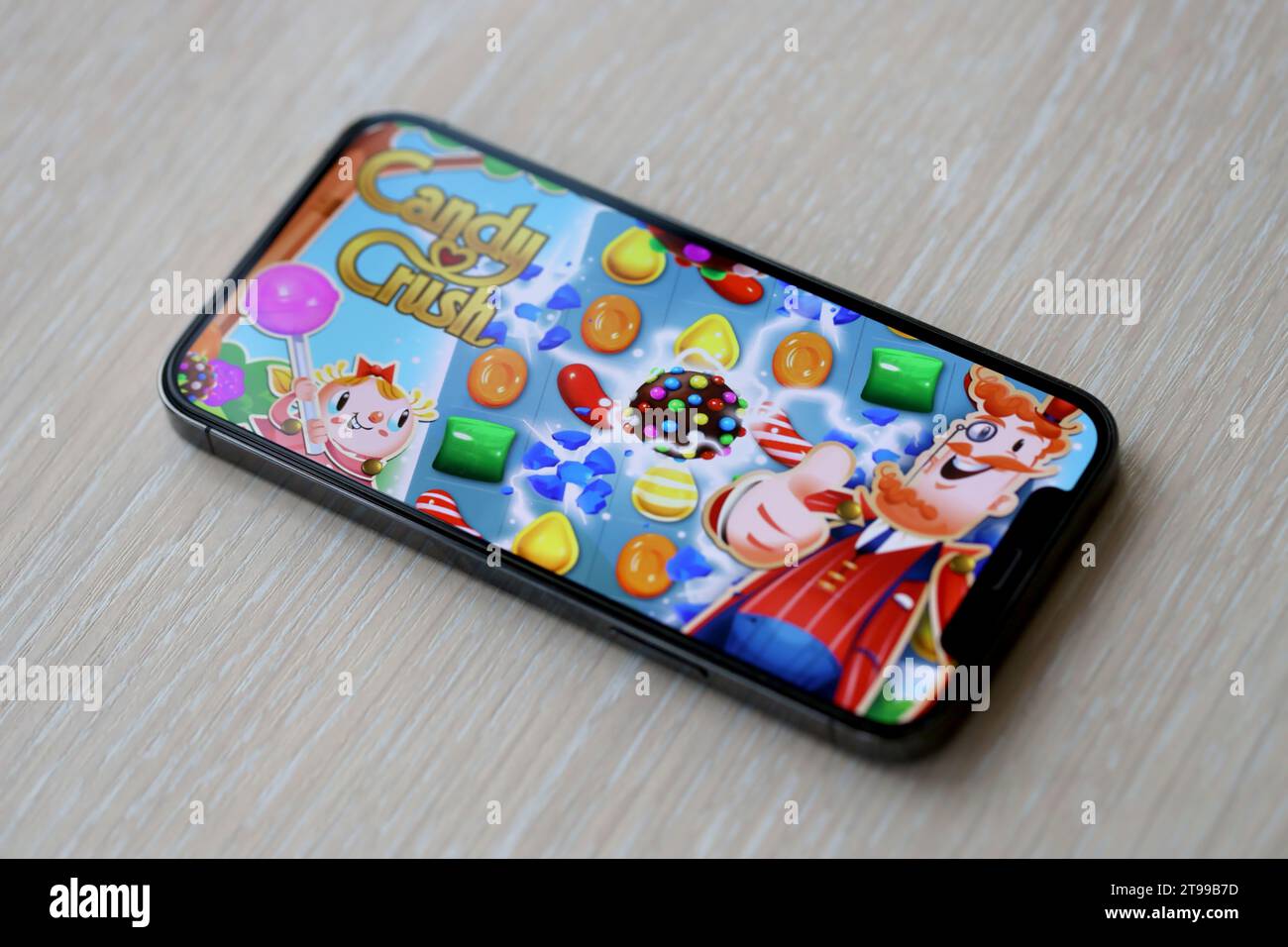 Candy Crush Saga mobile iOS game on iPhone 15 smartphone screen on ...