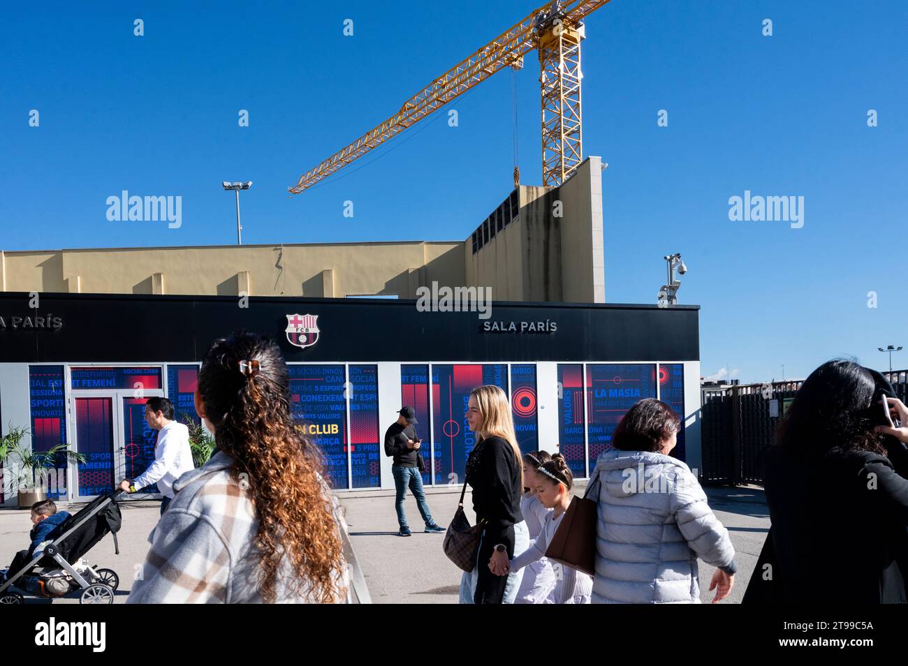 Visitors walk past the construction work that begun June on the new ...