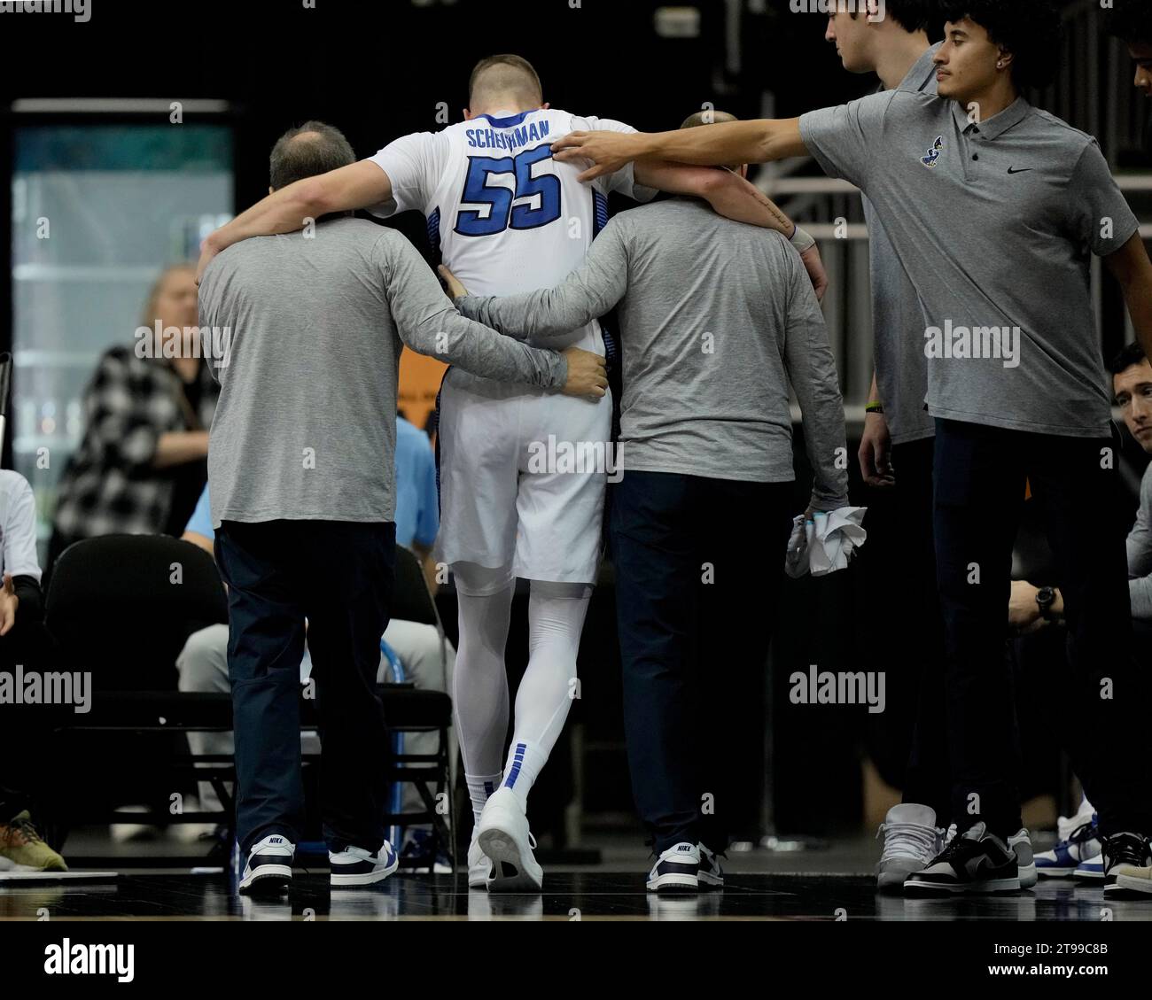 Creighton guard Baylor Scheierman (55) is helped off he court after an ...