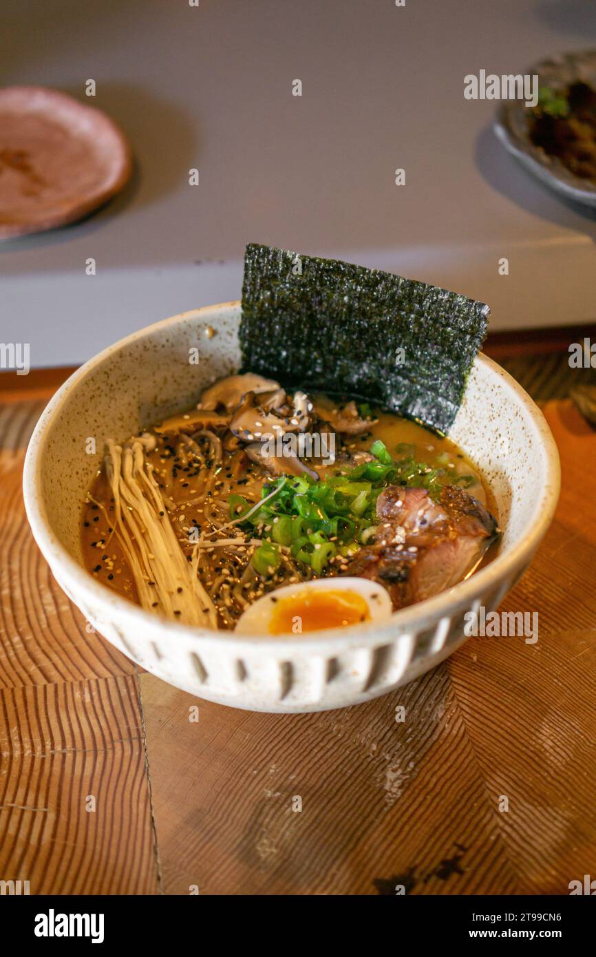 Miso Ramen with handmade noodles and a crispy nori, served on a white ...