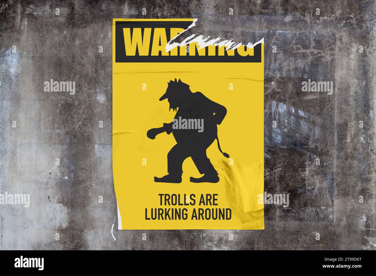 Full-frame weathered concrete wall with a torn yellow poster in the ...