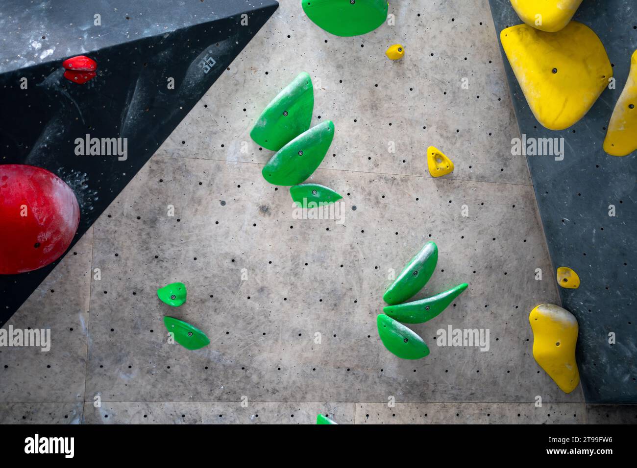 Colored bright painted climbing wall for training at bouldering gym ...