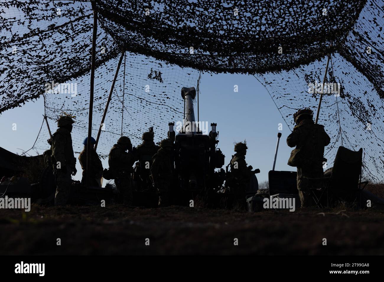 Japan Ground Self-Defense Force service members prepare to fire a FH-70 ...