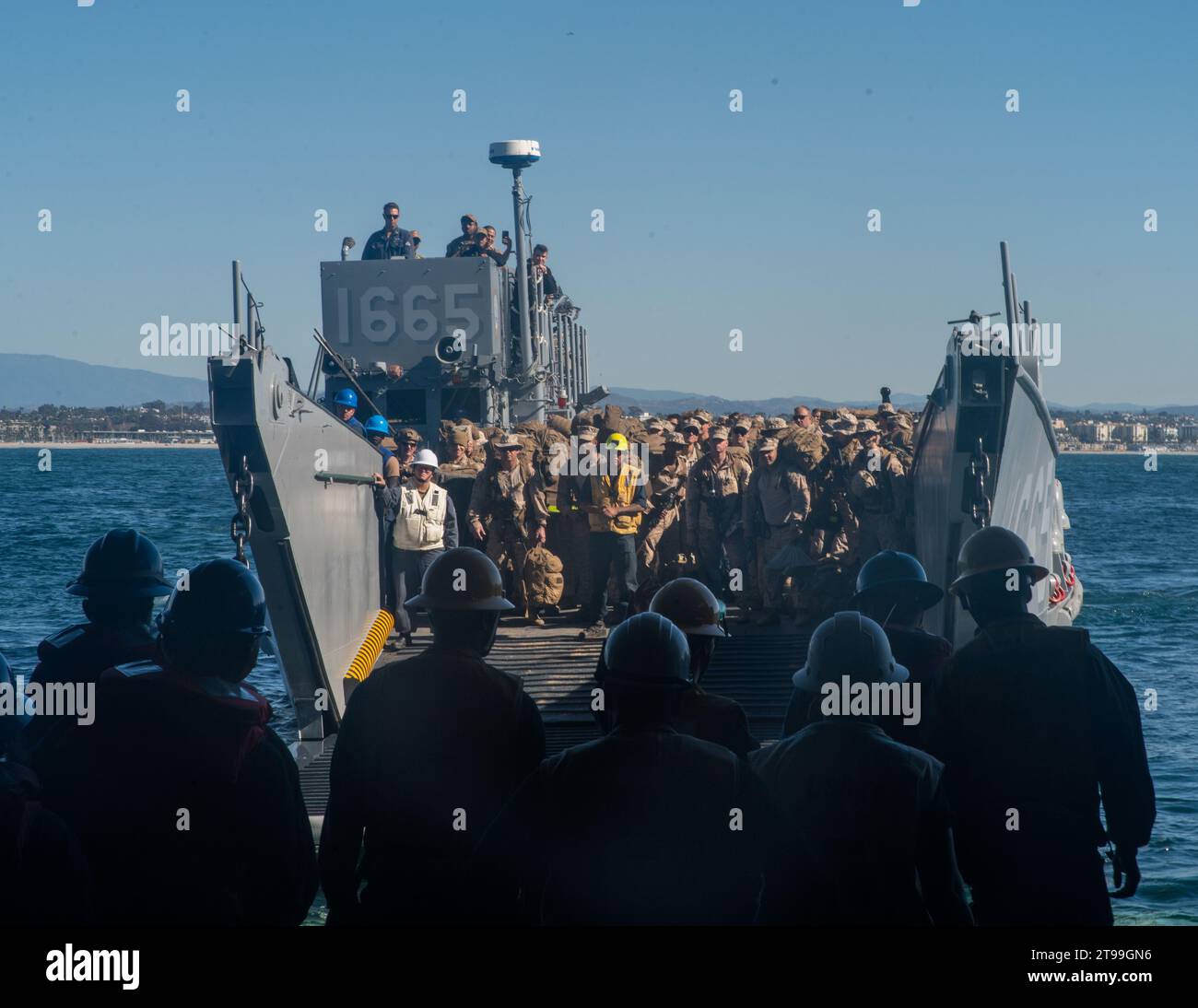 U.S. Sailors assigned to the amphibious dock landing ship USS Harpers ...