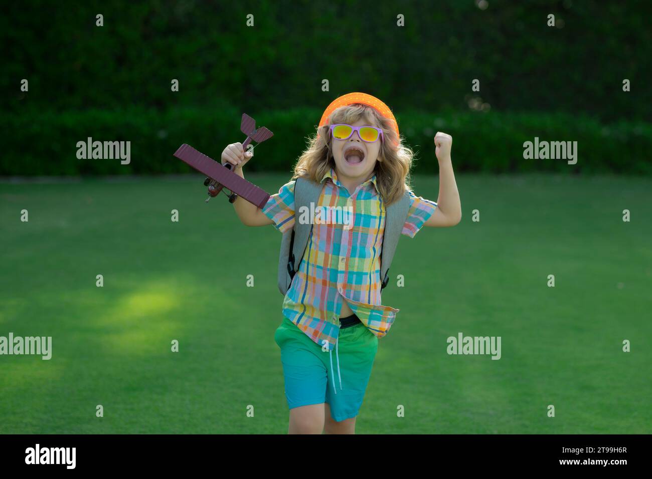 Boy kid dreams of becoming a pilot. Child playing with plane wings ...