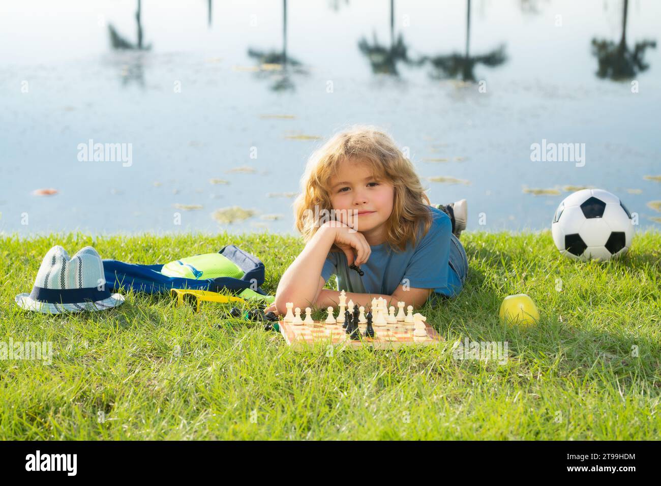 Little kid play chess in park. Child boy playing board game outdoor ...