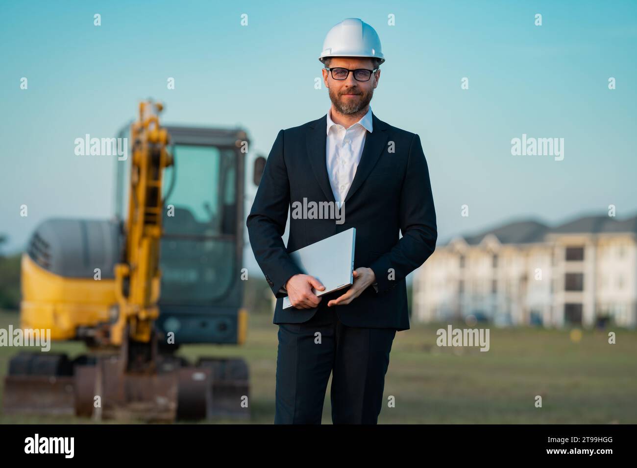 Construction owner near excavator. Confident construction owner in ...