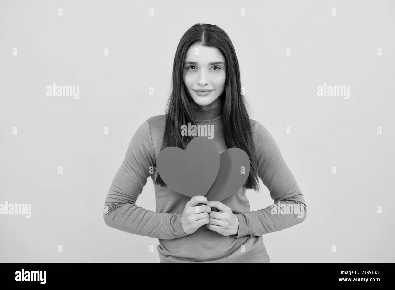 Happy woman hold red heart. Beautiful female model posing on isolated ...