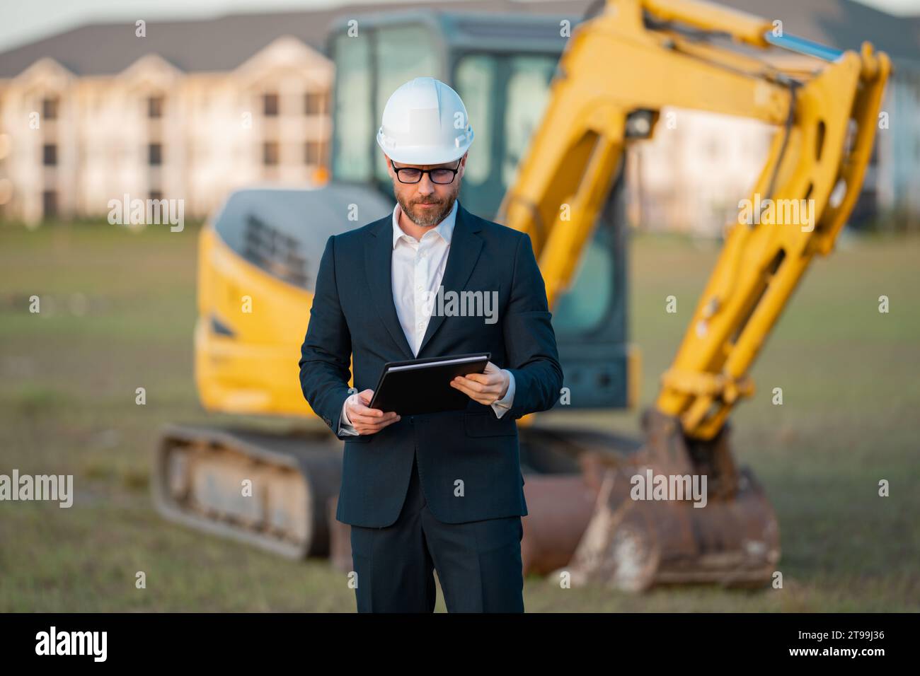 Civil engineer worker at a construction site. Engineer man in front of ...