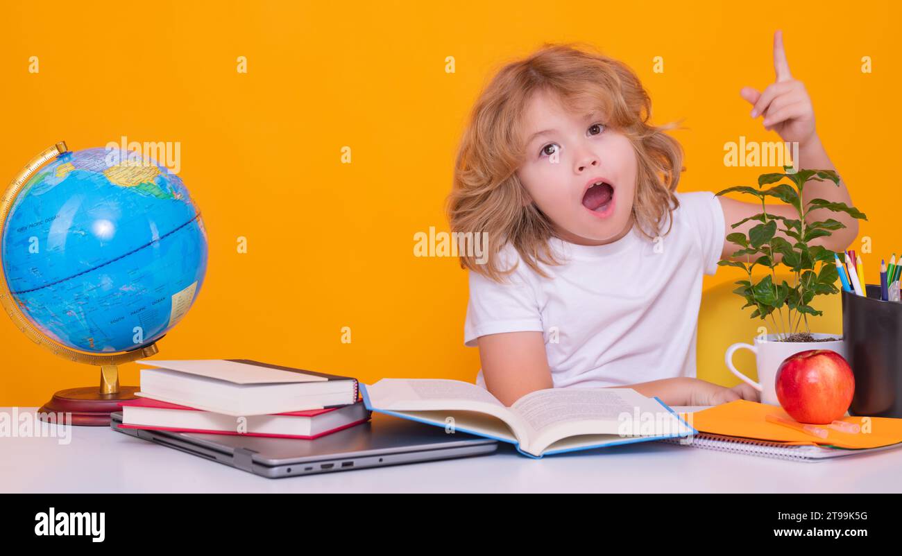 School kid holding index finger up with great new idea. School child ...