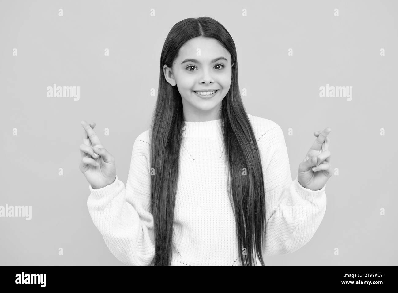 Joyful teenager girl fingers crossed, makes desirable wish, waits for ...