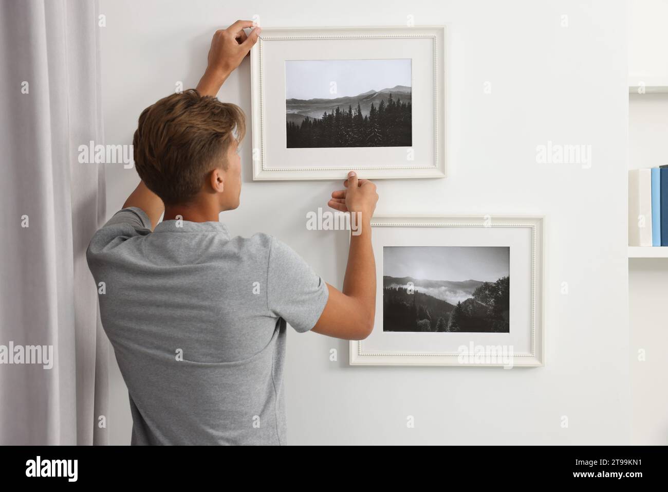 Back view young man putting hi-res stock photography and images - Alamy