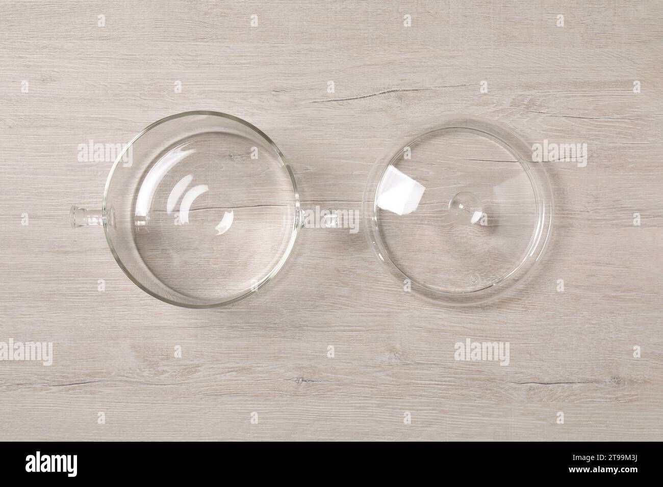 One empty glass pot and lid on light wooden table. flat lay Stock Photo ...