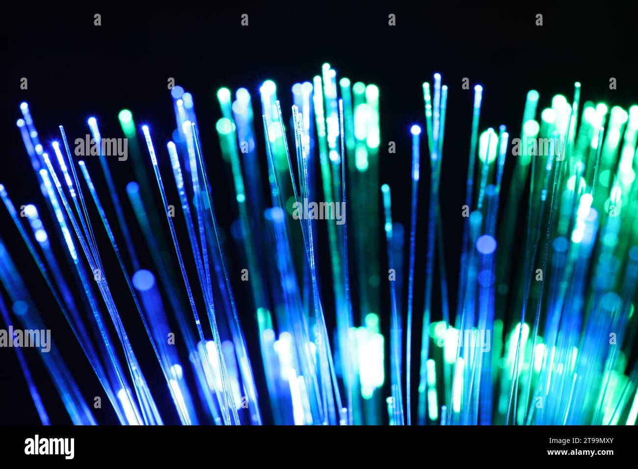Optical fiber strands transmitting different color lights on black ...