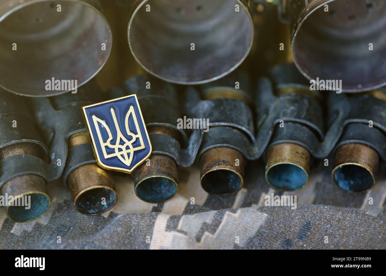 Ukrainian symbol on machine gun belt lies on ukrainian pixeled military ...